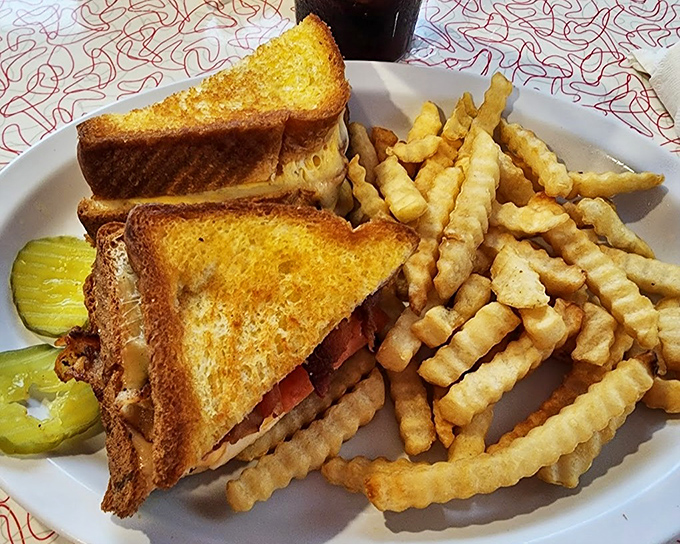 The patty melt &ndash; that perfect marriage of grilled beef, melted cheese, and caramelized onions &ndash; arrives with a mountain of crispy crinkle-cut fries.