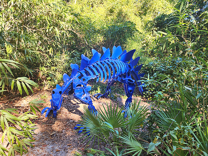 This brilliant blue stegosaurus, crafted from recycled materials, adds prehistoric whimsy to the forest floor&mdash;dinosaurs never looked so good!