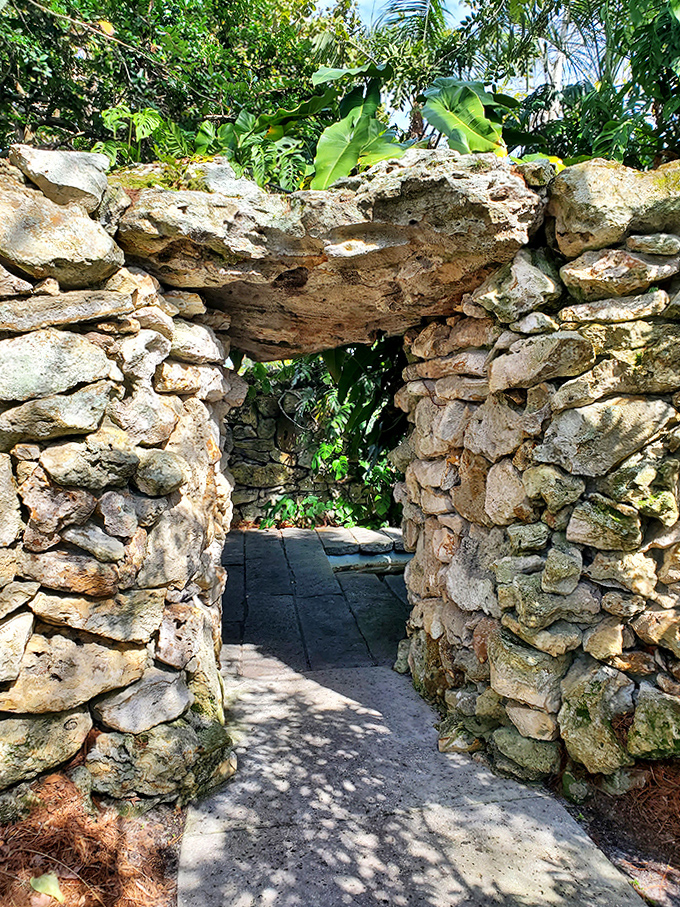 This rustic stone archway invites exploration, promising hidden garden rooms beyond &ndash; Indiana Jones for the horticultural set.