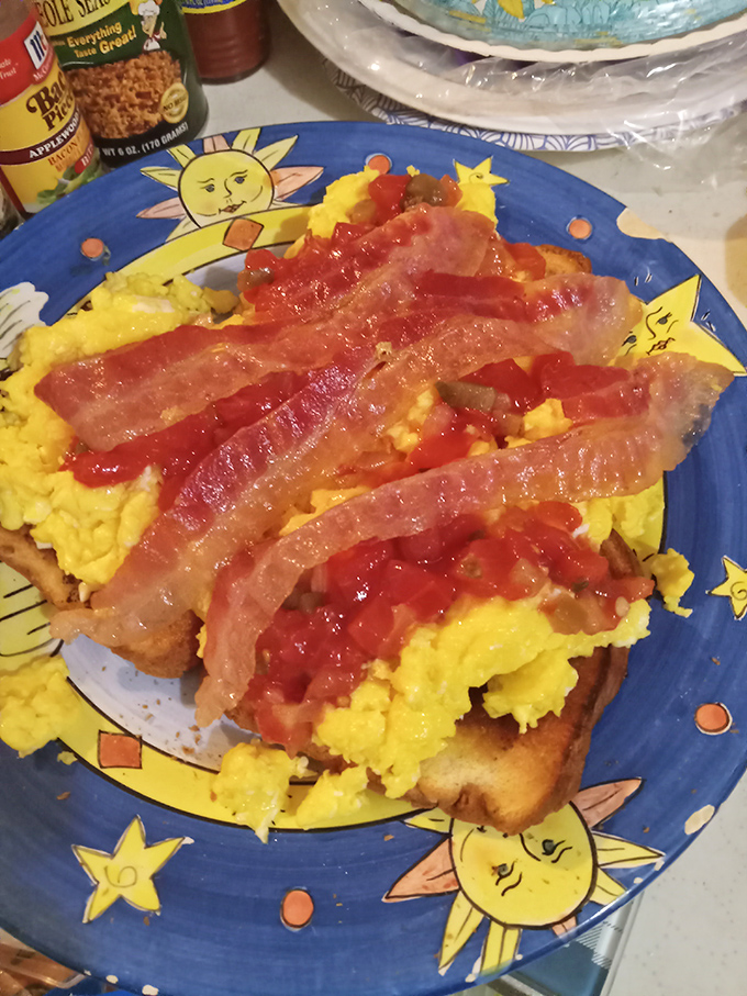 Sunshine-yellow scrambled eggs topped with crispy bacon strips &ndash; breakfast doesn't get more straightforward or more satisfying than this classic combination.