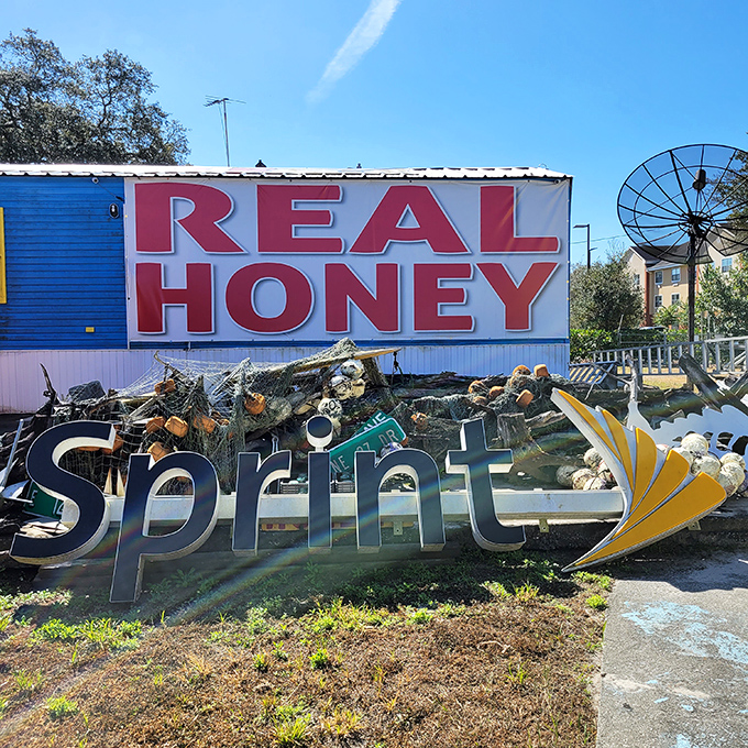 "REAL HONEY" and "Sprint" signs create an unexpected dialogue about consumption and waste against the backdrop of creative reuse.