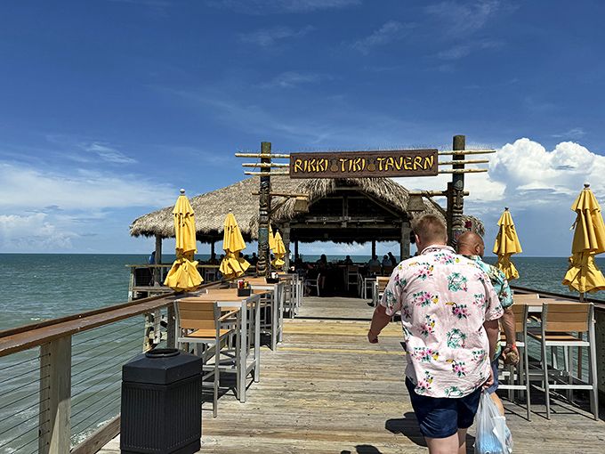 The weathered sign welcomes visitors like an old friend, promising tiki vibes and ocean views that Instagram filters couldn't improve if they tried.