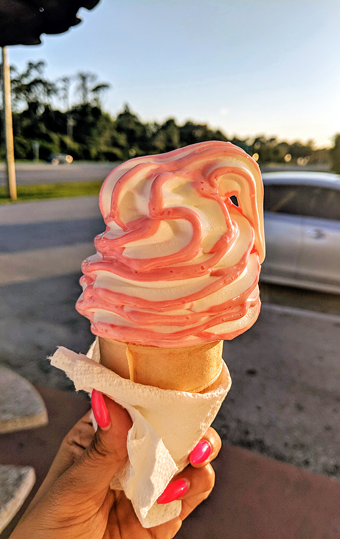 This strawberry-swirled soft serve defies gravity and expectations, its perfect peaks and valleys creating a landscape of deliciousness that demands to be explored bite by bite.