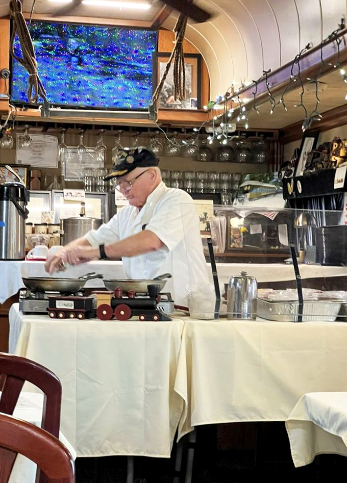Watch as skilled staff prepare your meal with practiced precision, turning the compact kitchen space into a stage for culinary performance.