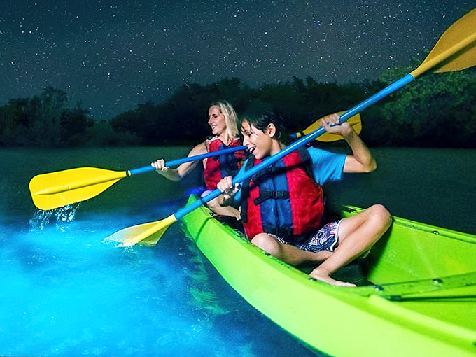 Tandem kayaking through bioluminescence: either the most romantic date ever or relationship counseling disguised as adventure.