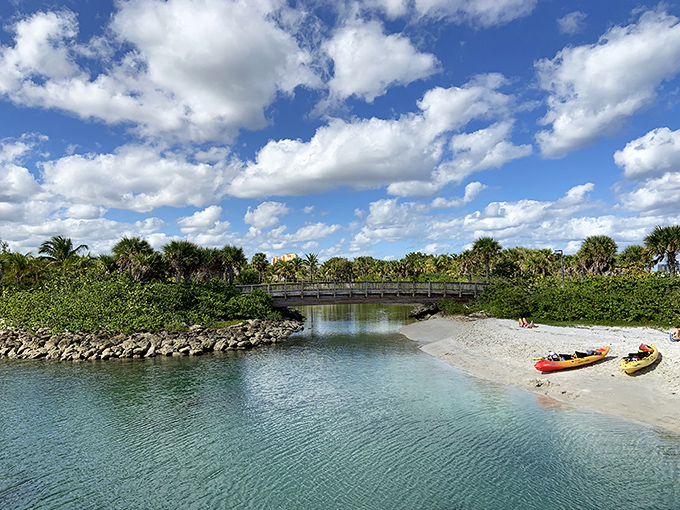 Where land meets lagoon &ndash; this picturesque bridge connects different worlds of the island, with kayakers enjoying the peaceful passage below.