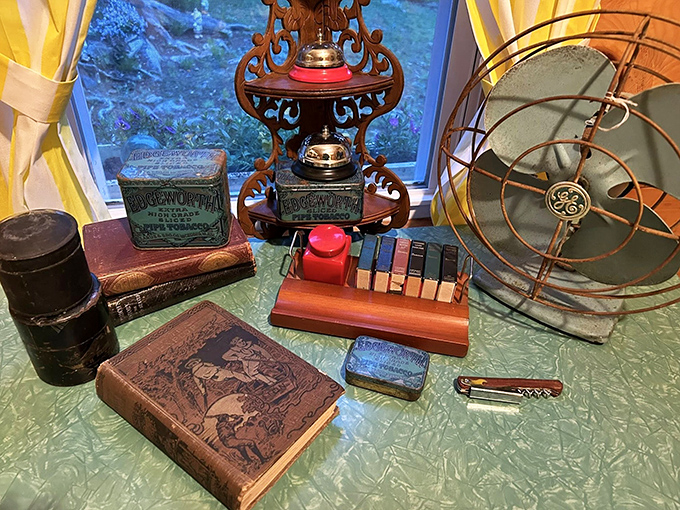 This vintage desk vignette features an antique fan, classic books, and office accessories that would make any home office infinitely cooler.