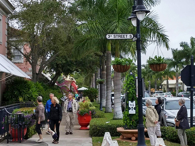 Visitors stroll along Third Street South, their relaxed postures telling the story of Naples' special brand of laid-back luxury.