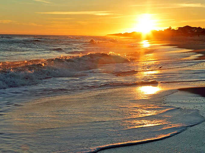 Nature's nightly masterpiece unfolds as the sun dips below the horizon, painting the sky and sea in impossible hues of gold and amber.