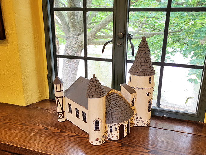 A miniature replica of the castle itself sits in a window, creating a charming meta-moment &ndash; a castle within a castle!