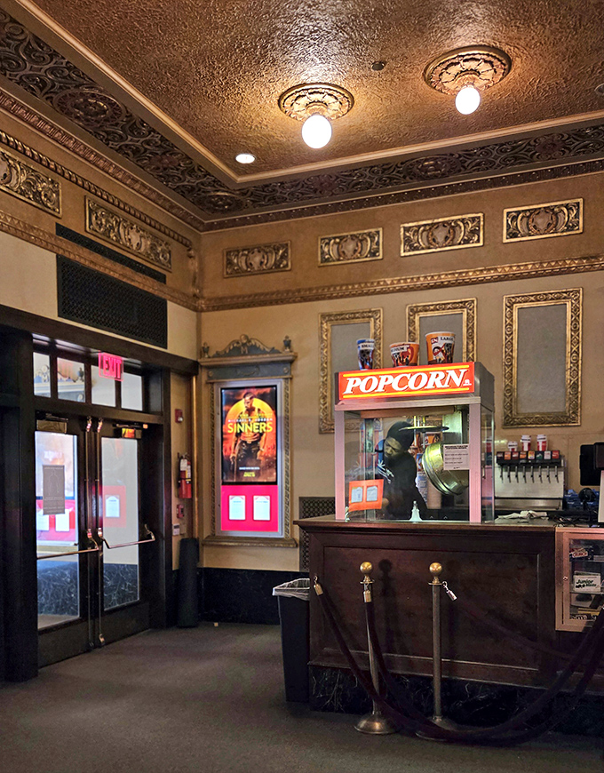 The concession stand nestles in gilded surroundings, serving treats worthy of the architectural splendor that frames your popcorn purchase.