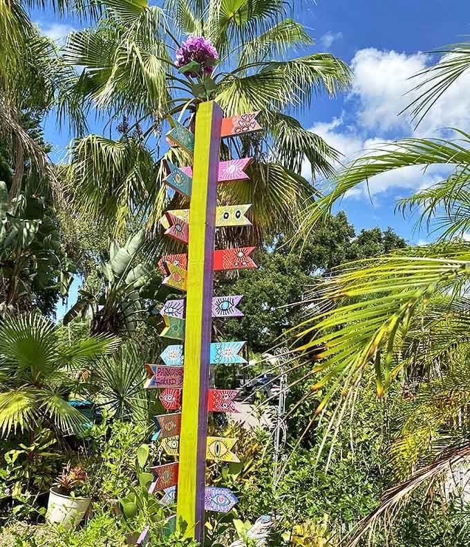 A rainbow totem pole of directional signs points everywhere and nowhere, suggesting that at Whimzeyland, all paths lead to wonder.