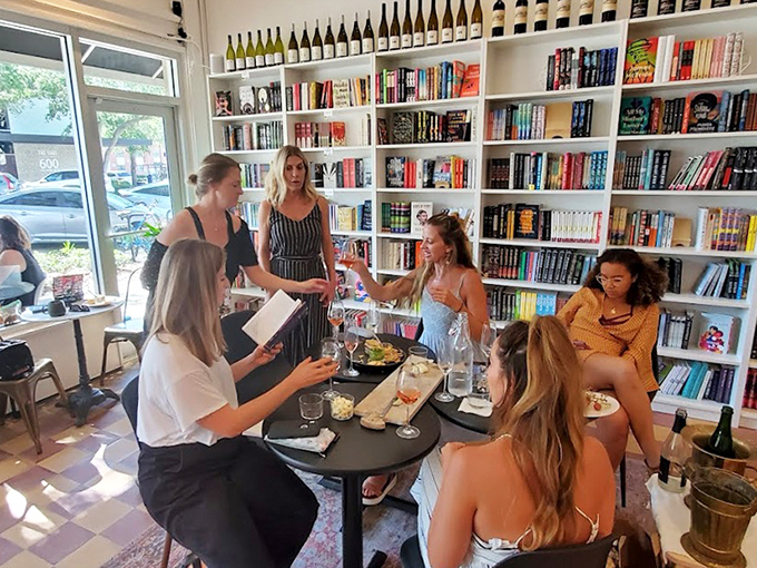 Glasses clink and pages turn as strangers become friends, united by shared discoveries and the magic of this literary watering hole.