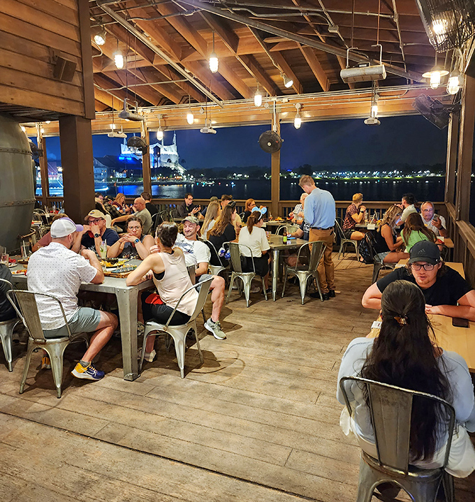 As evening falls, the outdoor deck transforms into a waterfront haven where conversations flow as freely as the cocktails.