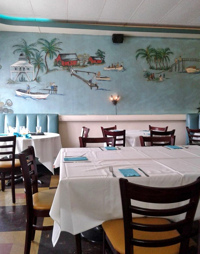 Coastal scenes painted on turquoise walls create an atmosphere of old Florida charm. White tablecloths and wooden chairs strike the perfect balance between casual and refined.