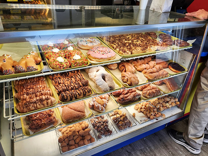 The display case stretches like a museum exhibit dedicated to the art of indulgence, with rows of freshly made treasures.