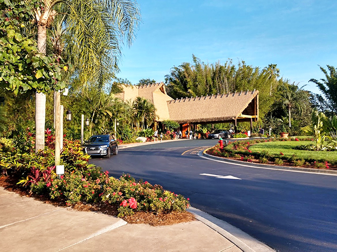 The entrance pathway welcomes visitors with tropical landscaping and thatched-roof architecture, setting the stage for an exotic escape.