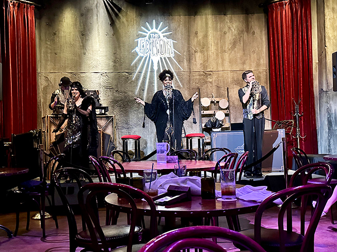 Performers transport diners to a Prohibition-era speakeasy, their voices soaring through the industrial space as The Edison transforms from restaurant to entertainment venue after dark.