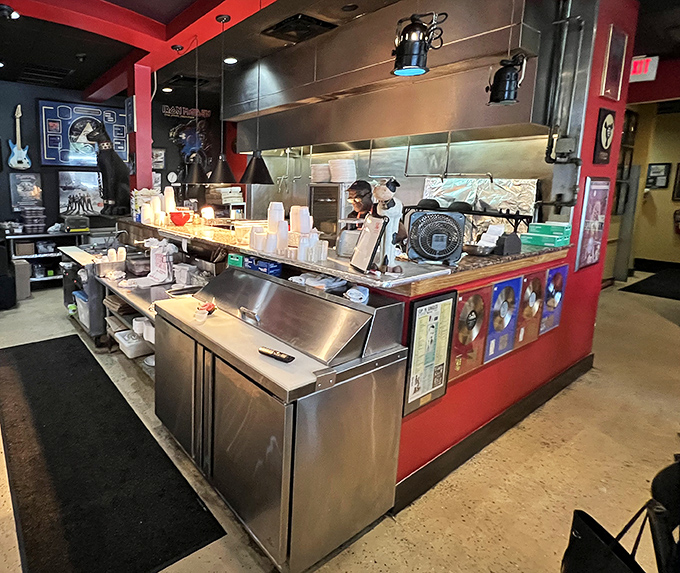 The open kitchen reveals barbecue artisans at work, orchestrating a symphony of smoke and flame with rock star precision.