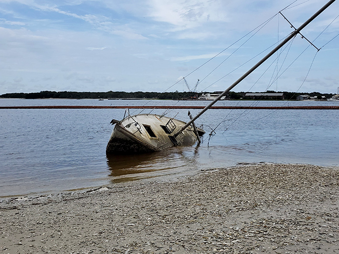 Maritime history comes alive with this partially submerged vessel, a reminder that these waters have witnessed countless journeys, triumphant and tragic.