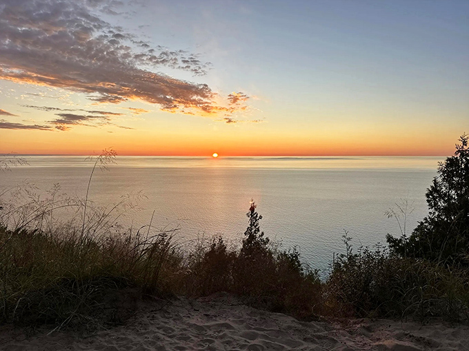 Sunset at Empire Bluff: When the sky puts on its evening wear and the lake dresses up to match, creating nature's perfect date night.