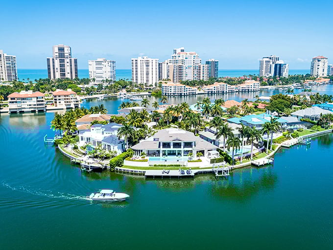 The coastal waters shift through shades of blue and green, creating a living painting that changes with the light.