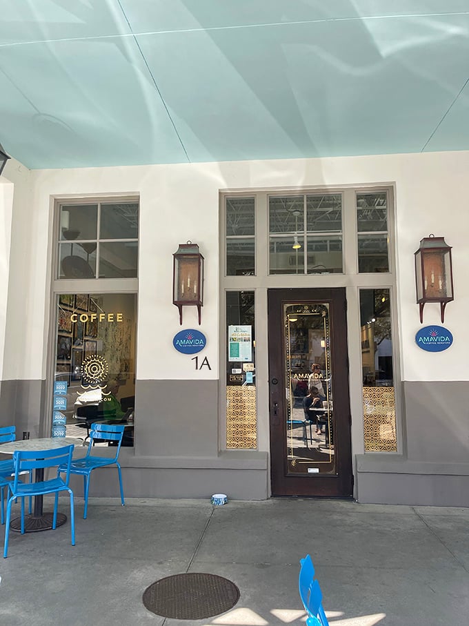Amavida Coffee Roasters, where vacation mornings officially begin. Those blue chairs aren't just seating&mdash;they're front-row tickets to the daily parade of beach life.