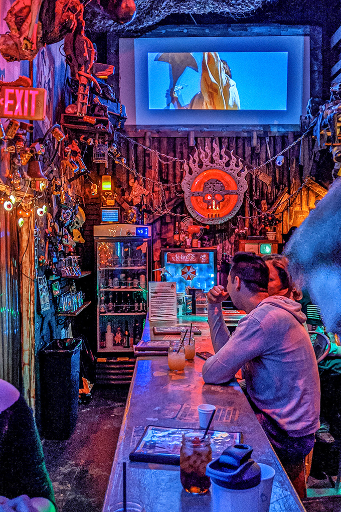 The bar area looks like it survived the end of the world, where patrons gather to swap tales of adventure while sipping otherworldly concoctions.