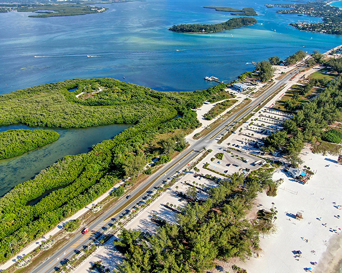 The bayside waters offer a gentler experience than the Gulf, perfect for paddleboarders, young swimmers, and contemplative sunset watchers.