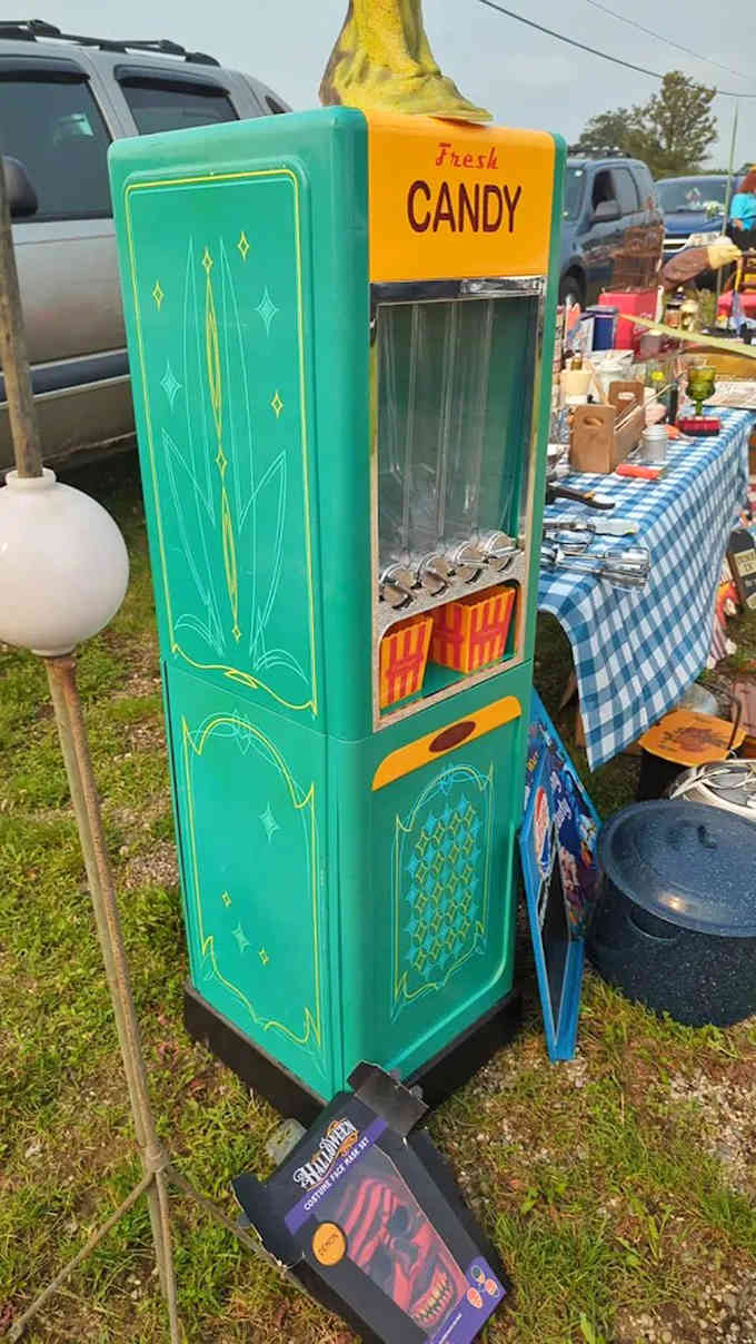 A vintage candy dispenser stands ready to brighten any room with its cheerful colors and nostalgic charm, making you wish pennies still had the purchasing power they did when this beauty was new.