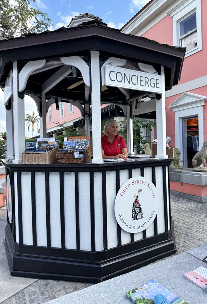 The concierge kiosk stands ready to guide newcomers through the Third Street South experience – because paradise sometimes needs a navigator.