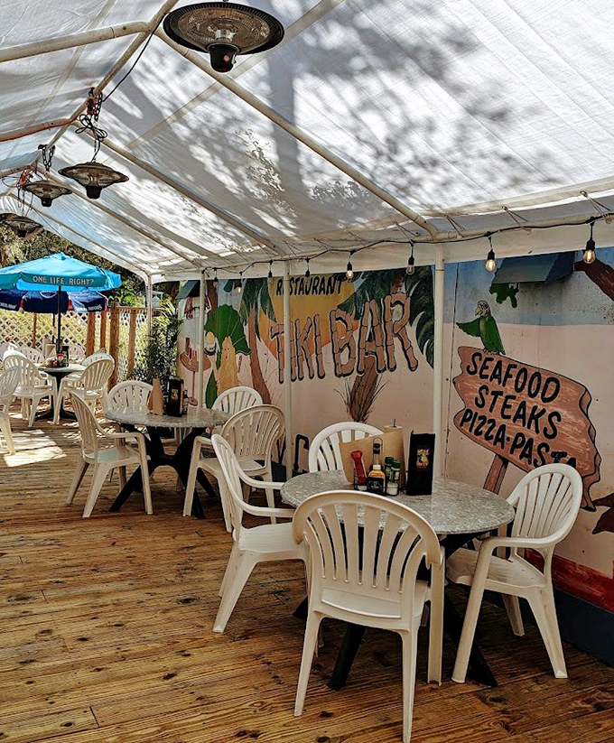 Dappled sunlight filters through this casual oasis where plastic chairs have never felt so inviting and seafood has never tasted so authentic.