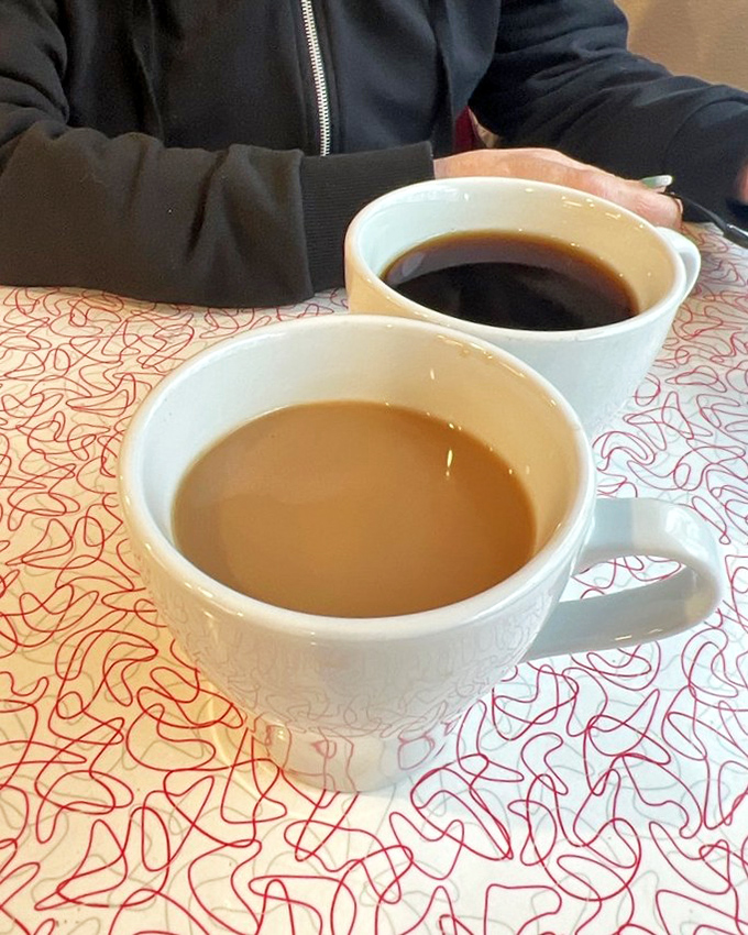 Coffee comes in sturdy white mugs that warm your hands while conversation flows as freely as the refills from friendly servers.