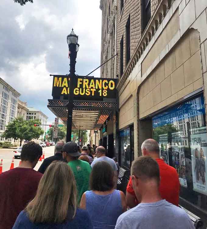 Eager patrons line up under the marquee, the anticipation building as they prepare to step from everyday Jacksonville into a world of vintage glamour.