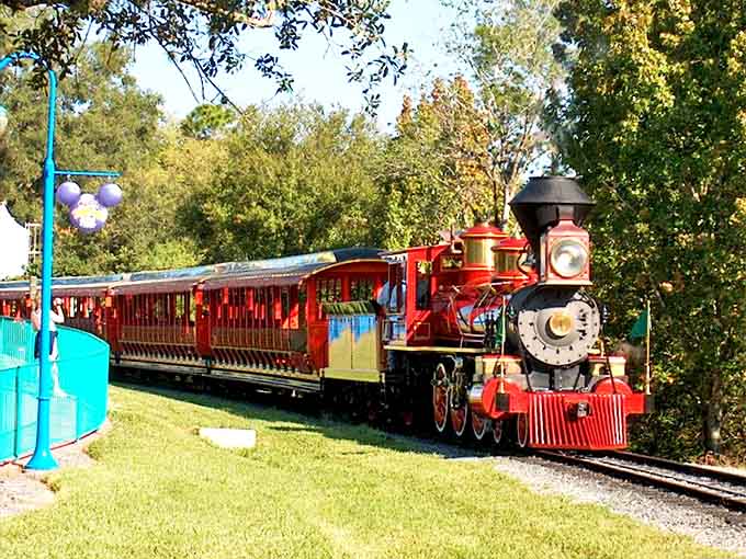 The Disney World Railroad offers unique vantage points of the park, including this picturesque view with vibrant landscaping framing the tracks.
