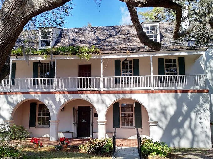 The house's elegant fa&ccedil;ade with its distinctive porch and arched entryways showcases the Spanish colonial influence that shaped early St. Augustine.