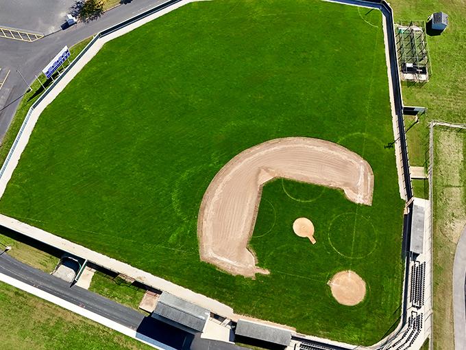 Larry Tuttle Field's pristine diamond has witnessed countless home runs, strikeouts, and the timeless tradition of parents cheering from uncomfortable bleachers.