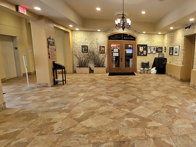 The renovated lobby welcomes visitors with warm lighting and exposed brick, showcasing how thoughtful restoration can honor history while creating inviting modern spaces.