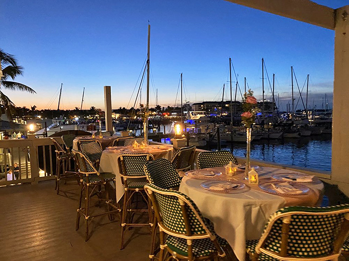 The marina view at sunset transforms ordinary dining into a postcard moment &ndash; boats silhouetted against a watercolor sky that changes by the minute.