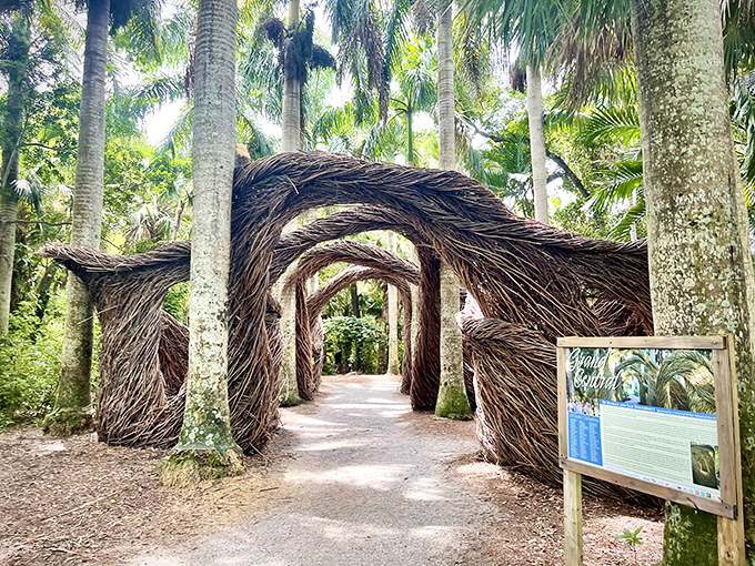 Nature meets artistry in McKee Garden's remarkable Stickwork sculpture, where woven branches create magical tunnels through tropical paradise.