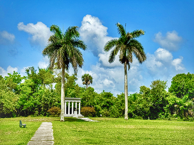 The architectural columns of royal palms stand like sentinels guarding the entrance to another natural Florida treasure, reminiscent of Miller Landing's charm.