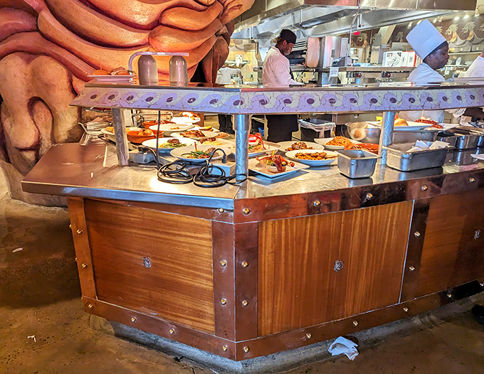 Where culinary magic happens &ndash; chefs craft Mediterranean masterpieces behind a counter that blends seamlessly with the stone surroundings.