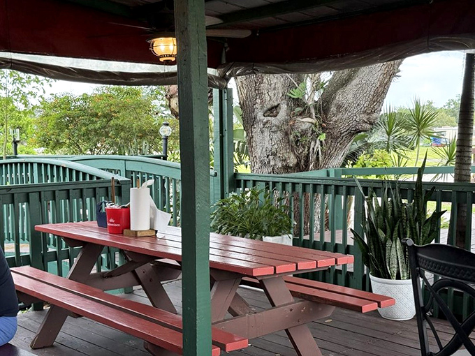 Outdoor dining under Florida skies, where picnic tables invite strangers to become friends over shared crab-cracking techniques.
