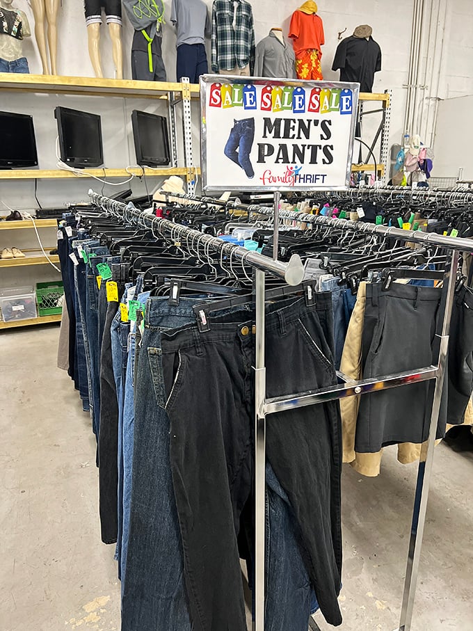 Men's pants section organized with military precision &ndash; denim, khakis, and dress slacks hanging in neat rows like soldiers awaiting their next mission.