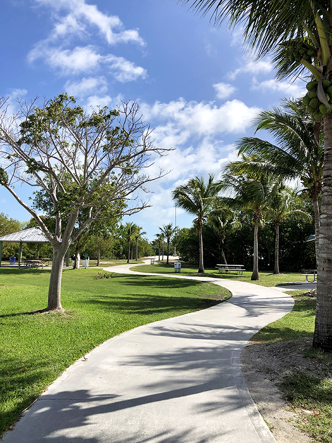 Winding paths through manicured grounds invite leisurely strolls where conversations flow as easily as the gentle bay breeze.