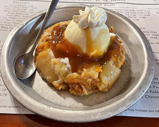The peach cobbler arrives like a warm Southern hug, crowned with melting ice cream and carrying the perfect balance of fruit sweetness and buttery crust.