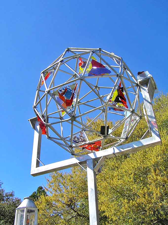 This metal geodesic sphere captures the property's blend of artistic vision and mathematical precision against the Florida sky.