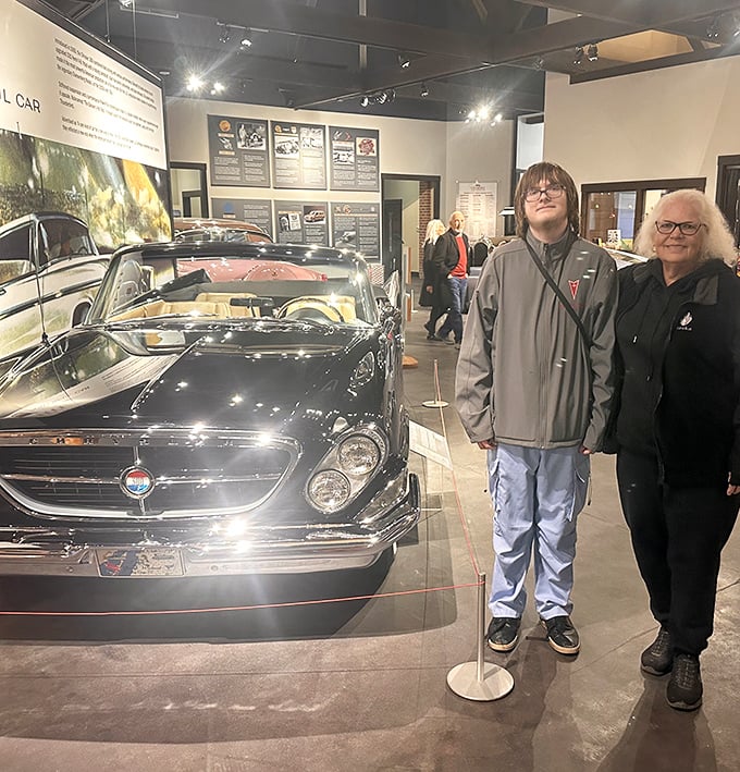 Visitors admire a classic convertible&mdash;the museum creates moments of connection between generations through shared appreciation of automotive history.