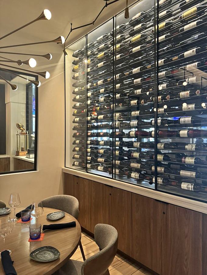 An impressive wall of bottles stands ready for your selection – from robust reds to crisp whites, this collection rivals the playbook in both depth and strategic options.