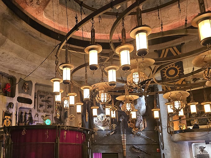 Hanging lanterns cast an otherworldly glow across the collection, creating an atmosphere that's equal parts ancient temple and futuristic bazaar.